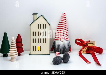 Christmas gnome with decorations on light wooden background Stock Photo ...