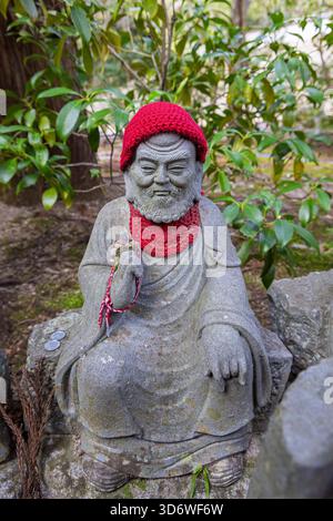 Buddha with red caps at Buddha temple Takifudo island Miyajima ...