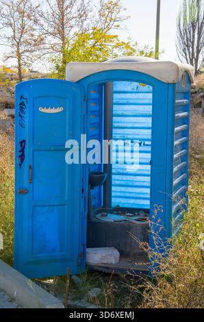 Abandoned Blue Portable Toilet in Overgrown Field with Open Door Stock ...