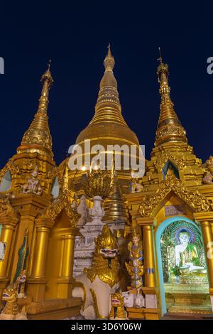 Small pagodas and statues in front of the gilded Shwedagon Pagoda in ...