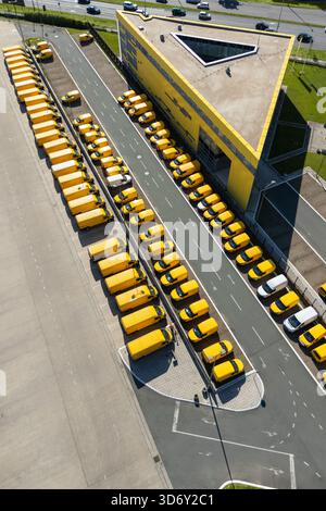 Delivery vans and trucks hub. Fleet of yellow post vehicles Stock Photo ...