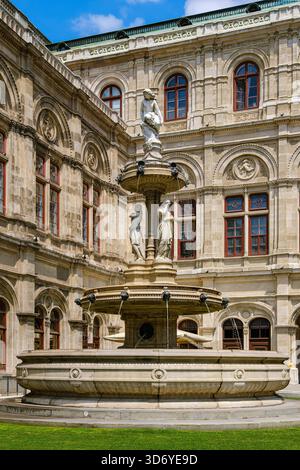 The Vienna State Opera in Austria at night with car lights in long ...