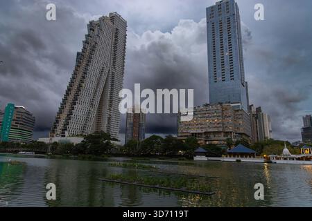 Modern Colombo skyline reflected in a lakeside view under dramatic ...