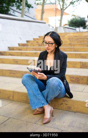 young digital nomad working remotely in Bali with silver laptop in hand ...