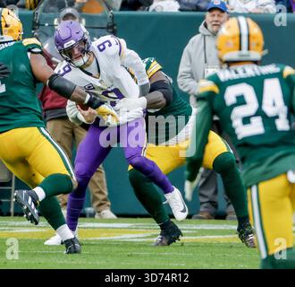 Green Bay Packers' Devonte Wyatt rides a bike to an NFL football joint practice session with the ...