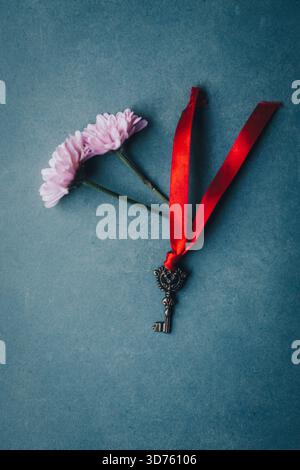 Old key with flowers and red ribbon Stock Photo - Alamy