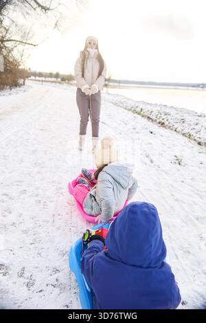 A woman pulls a child through the snow after a winter storm in Toronto ...