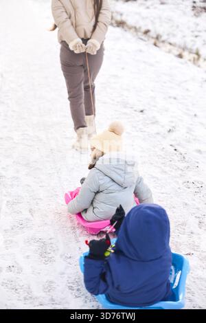 A woman pulls a child through the snow after a winter storm in Toronto ...