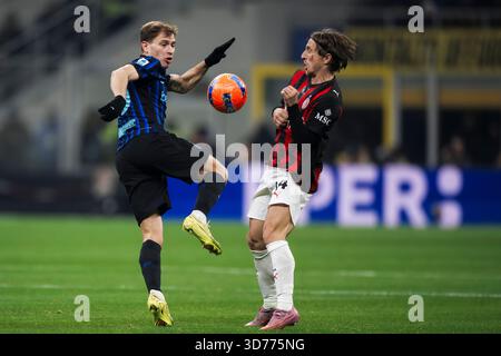 Luka Modric of AC Milan competes for the ball with Nicolae Stanciu of ...