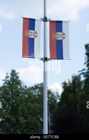 Two Serbian flags displayed on a pole Stock Photo - Alamy