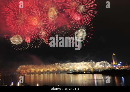 Spectacular Multicolored Fireworks Bursting over Waterfront Cityscape ...
