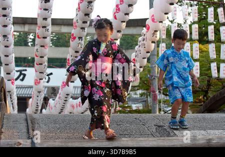 Children in traditional summer-weight kimono, called Yukata, watch ...