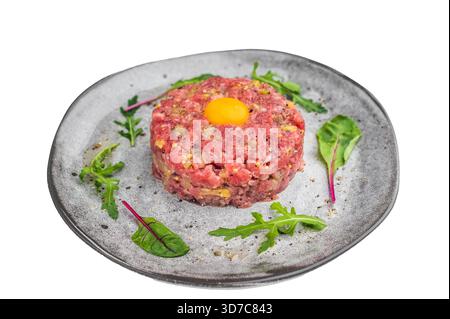 Fresh steak tartare with mustard pickles and herbs served on light ...