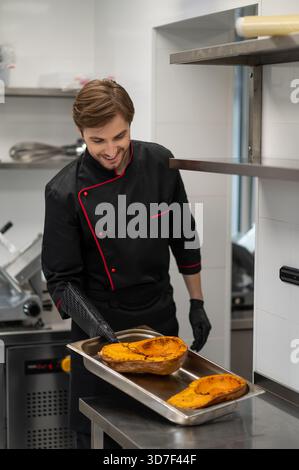 Professional chef using baking oven at his restaurant kitchen Stock ...