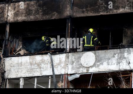 Emergency crews operate at the scene of a residential building struck ...