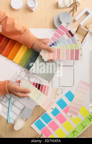 Male furniture designer with color palettes on table, top view Stock ...