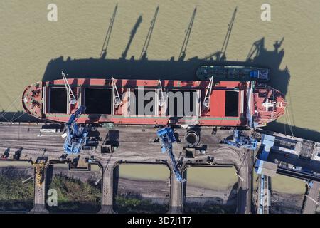 A cargo ship unloads coal at a Yangtze River coal terminal in Nanjing ...