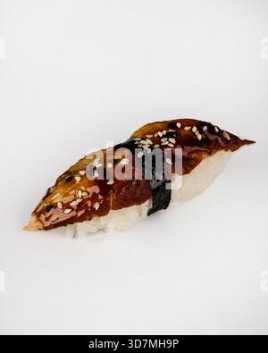 Grilled unagi eel with teriyaki sauce and sesame seeds on ceramic plate ...