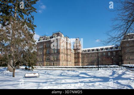 A scenic view of a bench against snowy mountains covered with green ...