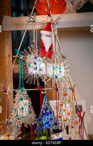 Christmas tree made of gifts and decorations on color background Stock ...