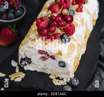 One baked bun with red strawberry jam on tray in electric oven: close ...