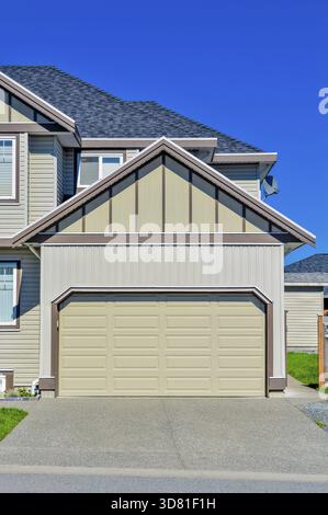 Wide garage double door and concrete driveway of new modern american ...