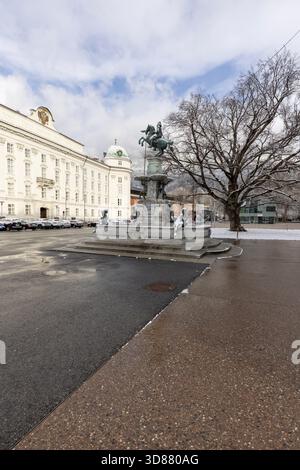 Snowy winter scene at historic palace by frozen lake. Royal Baths Park ...