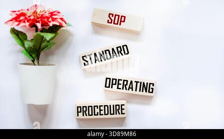 SOP - Standard Operating Procedure symbol. Wooden blocks with word SOP ...