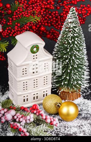 Ceramic christmas miniature house with spruce on the white background ...