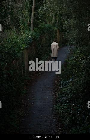 Woman in a coat in Secret Forest Stock Photo - Alamy