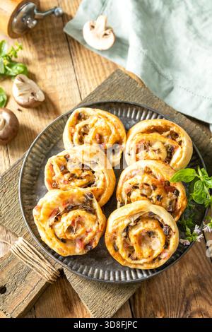 puff pastry roll with cheese on a wooden plate Stock Photo - Alamy