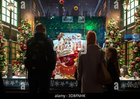 A family look at the Hamleys Christmas Window Display on Regent Street ...