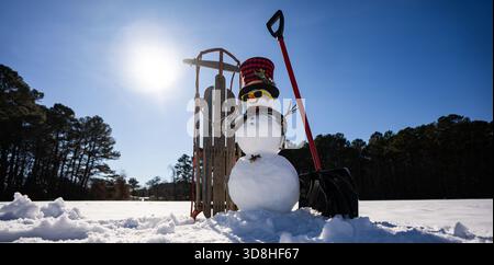 Snowman helping to clean the snowy road. Cute snowman prepared for snow ...