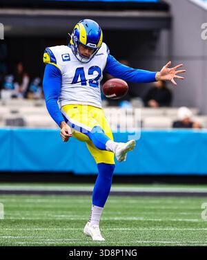 Los Angeles Rams punter Ethan Evans (42) holds the ball while kicker ...