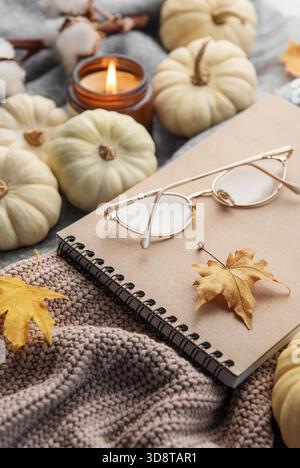 Autumn composition. Cozy home atmosphere with candle, notepad, dry ...