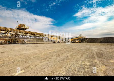 At a copper mine, a mobile conveyor system steadily builds a leaching ...