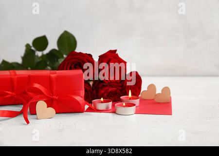 Gift boxes, rose flowers, envelope and hearts isolated on white ...