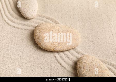 Composition with spa stones and lines on sand as background, closeup ...