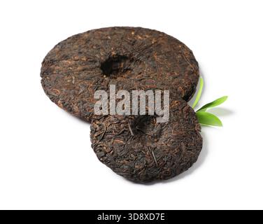 Dry compressed puer tea with fresh leaves on white background Stock ...