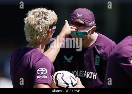 England’s Jacob Bethell (left) and Zak Crawley (right) walk out to bat ...