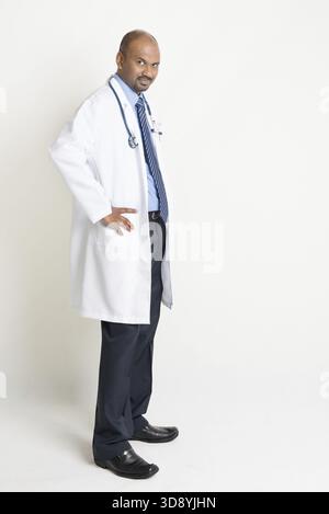 Side view full length confident male medical doctor in uniform looking ...