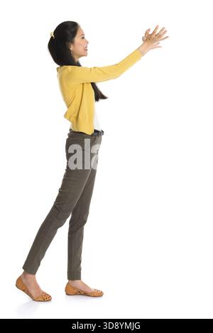 Full length profile shot of a girl with balloons running towards santa ...