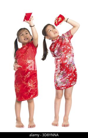 Child with a red packet isolated on green background. Little beauty ...
