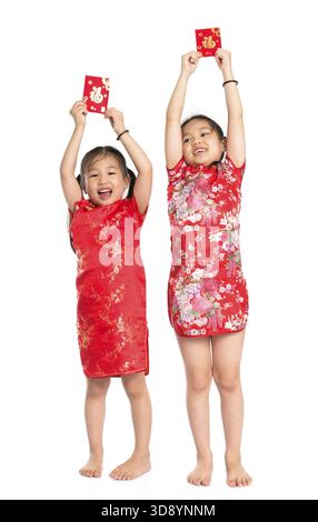 Child with a red packet isolated on green background. Little beauty ...
