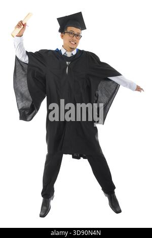 Full body excited Asian male university student in graduation gown ...