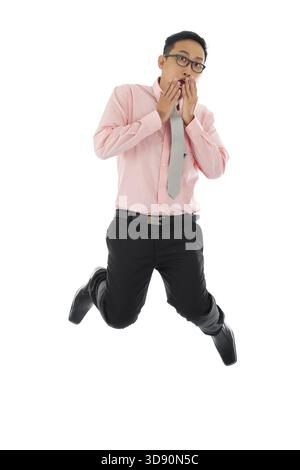 Shocked jumping young man on color background Stock Photo - Alamy