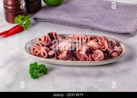 Marinated canned mini baby octopus in the bowl Stock Photo - Alamy