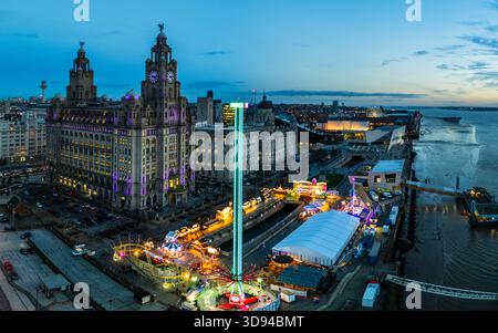 Amusement and fair ground rides captured against the Liverpool skyline ...