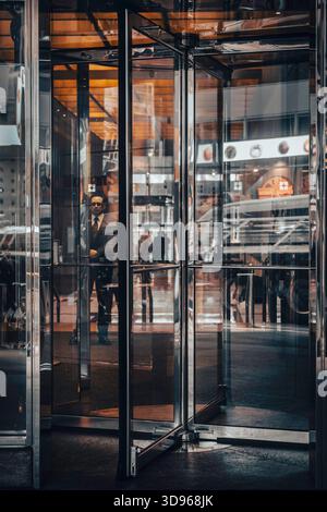 Glass revolving door in building foyer Stock Photo - Alamy