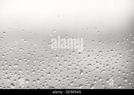 perfect backlit chaotic water drops on white light glass background ...